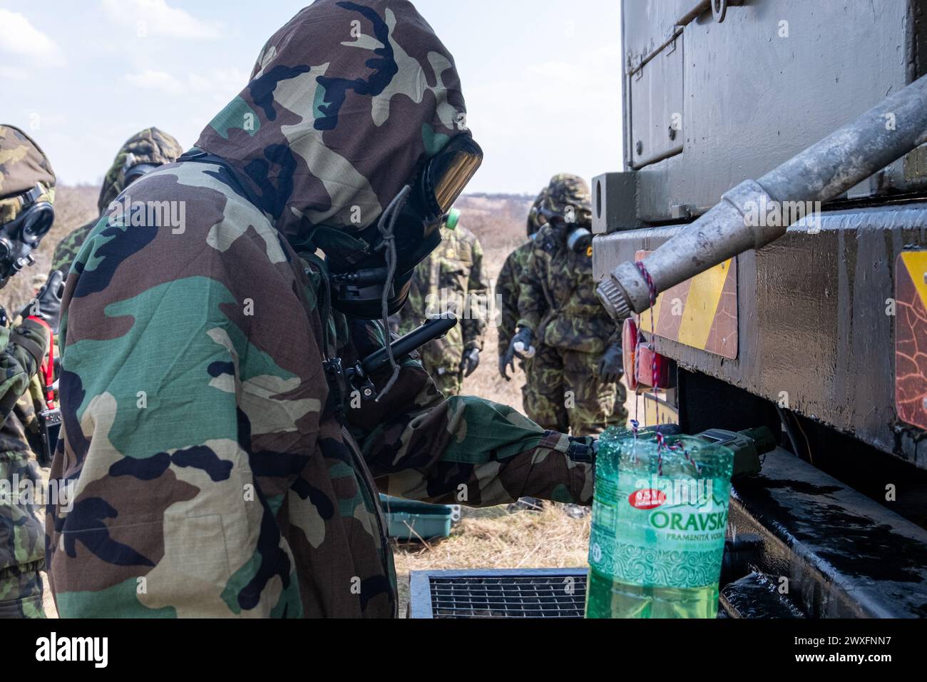 Multiple soldiers in hazmat suits are scanning for contaminants on the ...