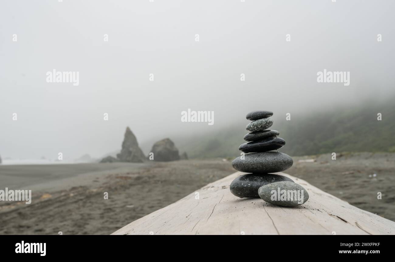 Stack of Gray Stones on Smooth Driftwood along the California Coastal ...
