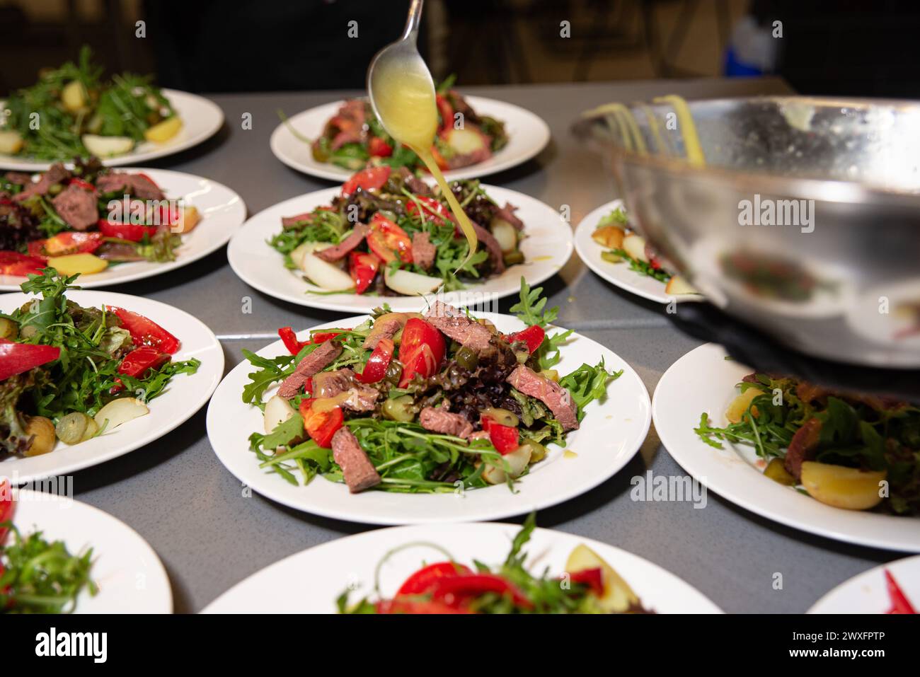 Chef dressing plates in commercial hi-res stock photography and images ...