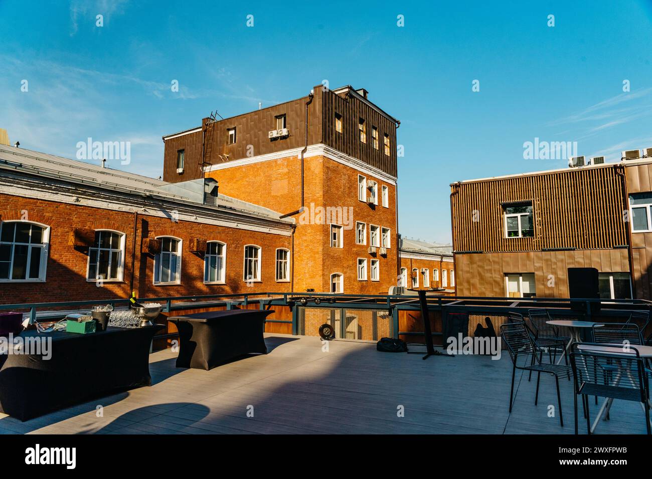 A modern veranda on the rooftop of a renovated building blends historic ...