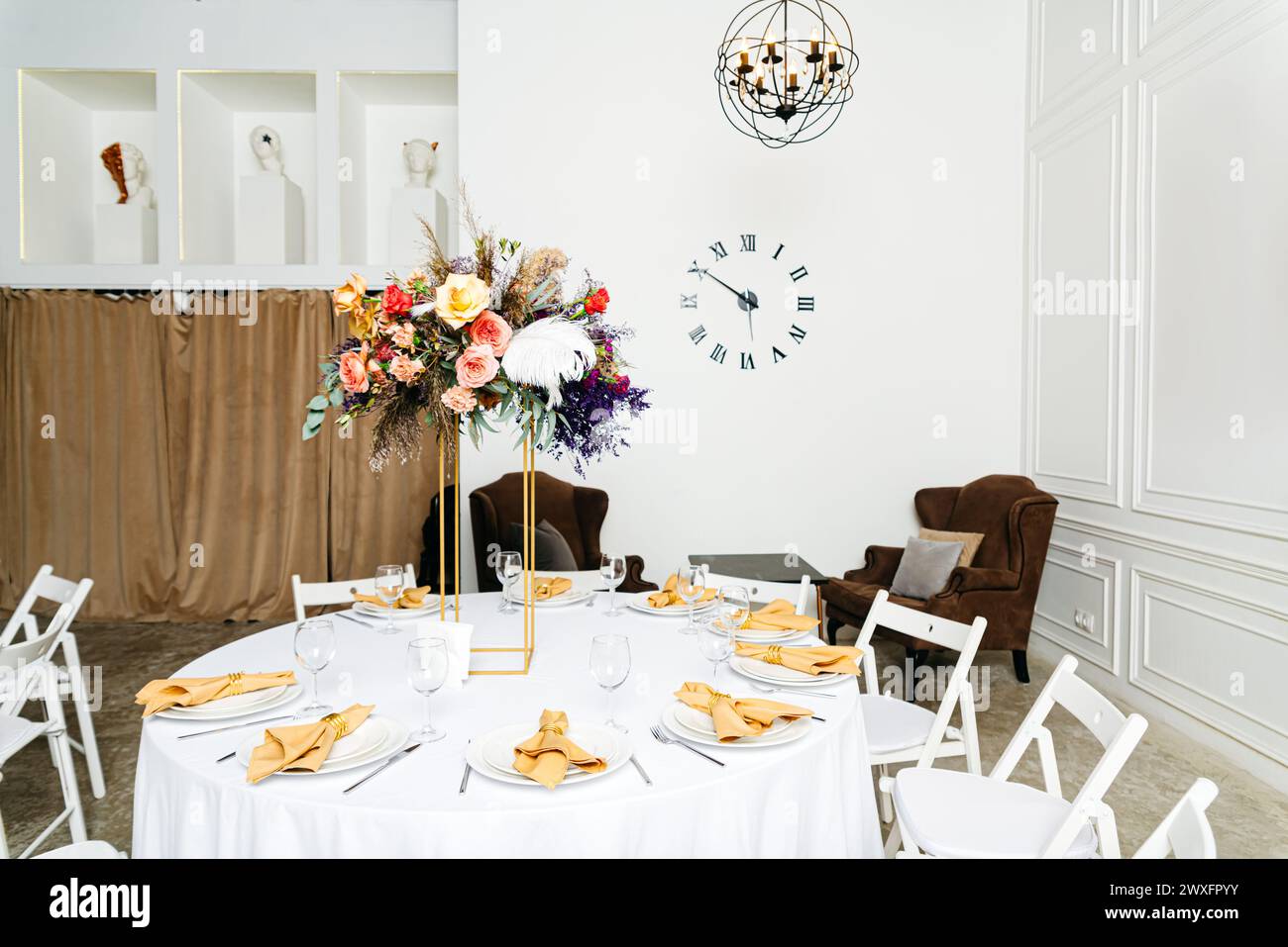 Sophisticated table setting for an event featuring a lavish floral ...