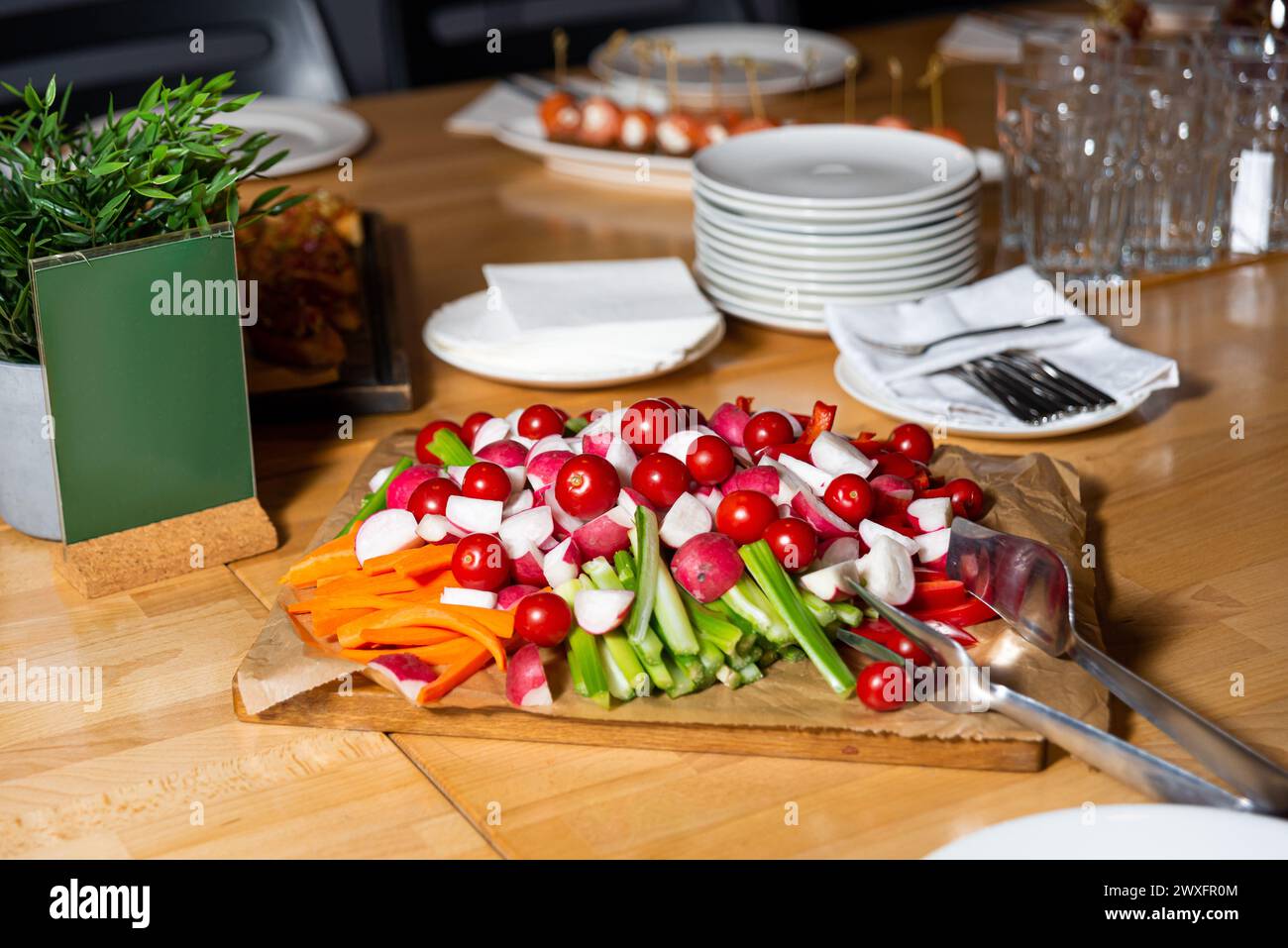 A vibrant crudité platter with an array of fresh vegetables, including ...