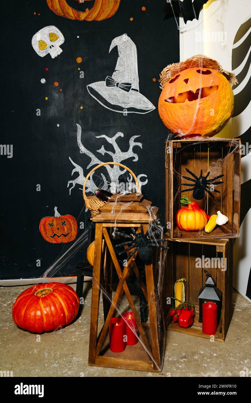A Halloween-themed display with a carved pumpkin, cobwebs, and various ...