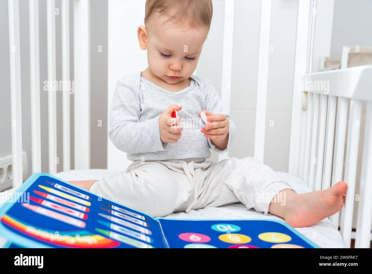 Baby in crib with books hi-res stock photography and images - Alamy