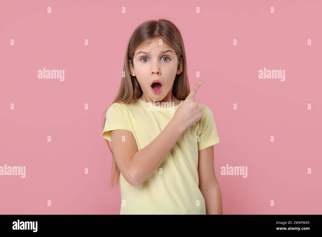 Surprised girl pointing on face hi-res stock photography and images - Alamy