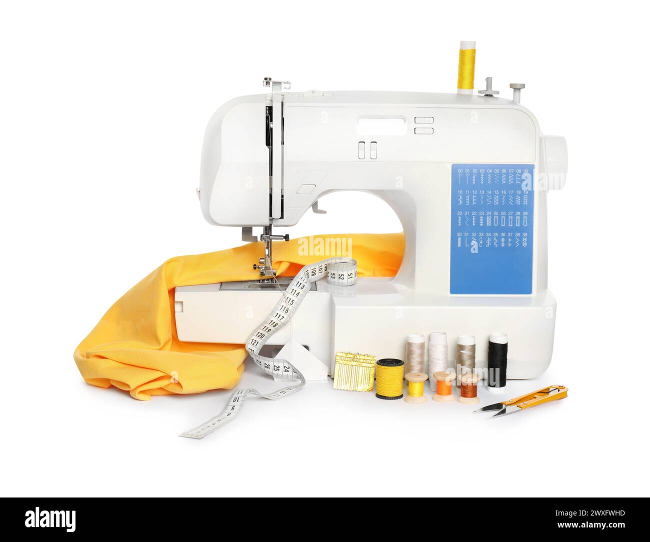 Sewing machine work yellow fabric Cut Out Stock Images & Pictures - Alamy
