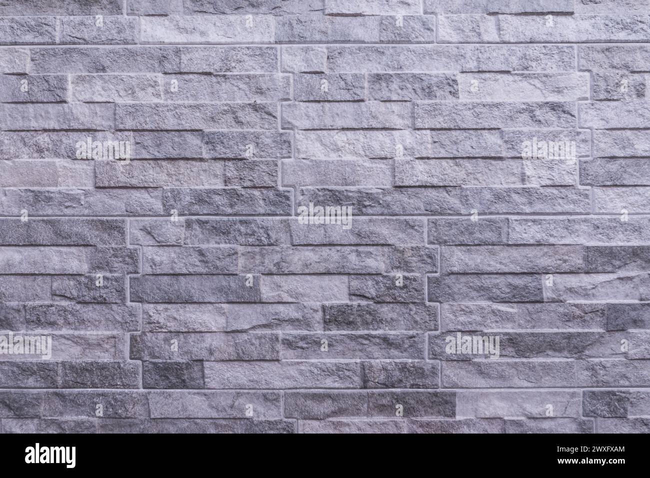 A wall of tiles that simulate gray stone bricks Stock Photo - Alamy