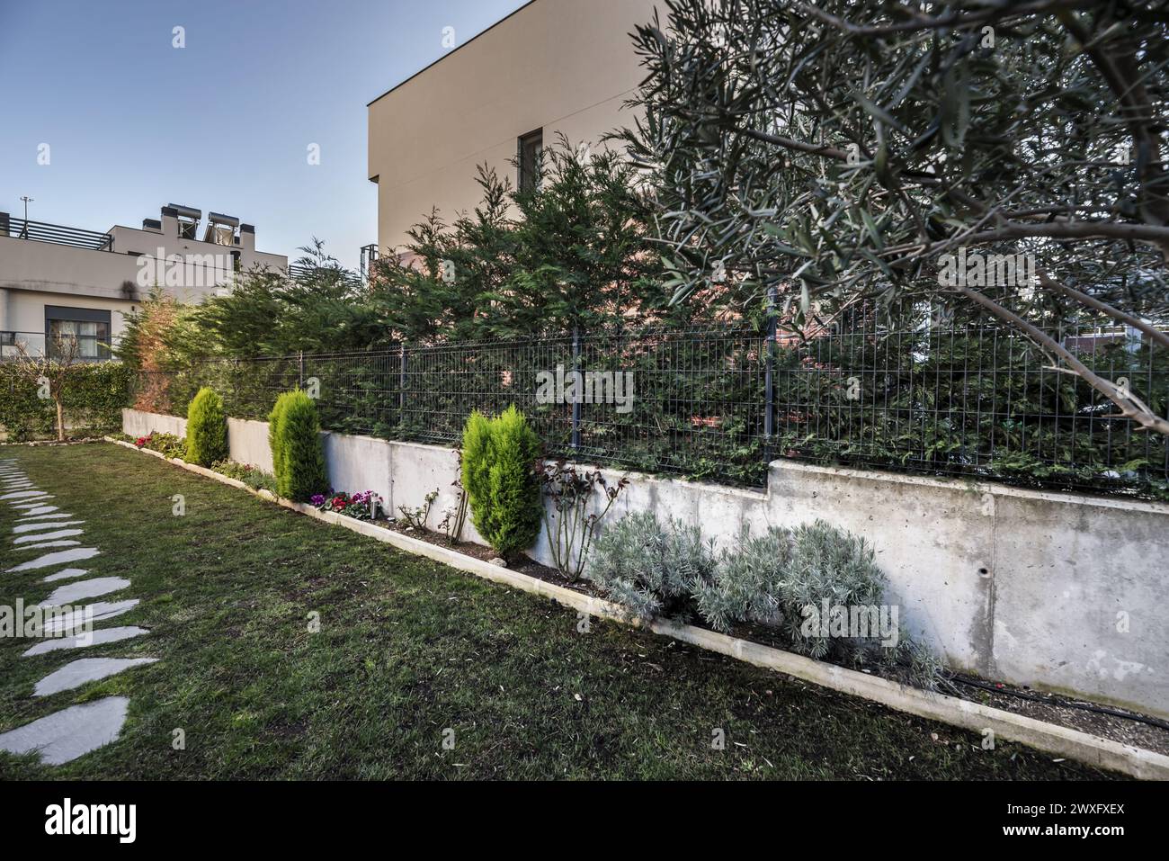 Garden of a multi-storey single-family house with slate paths attached ...