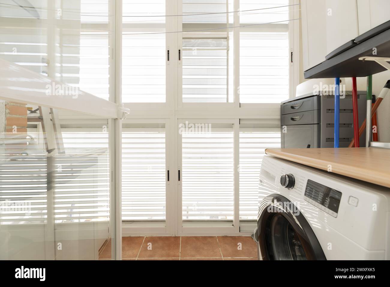 small laundry terrace with washing machine, white aluminum window and ...