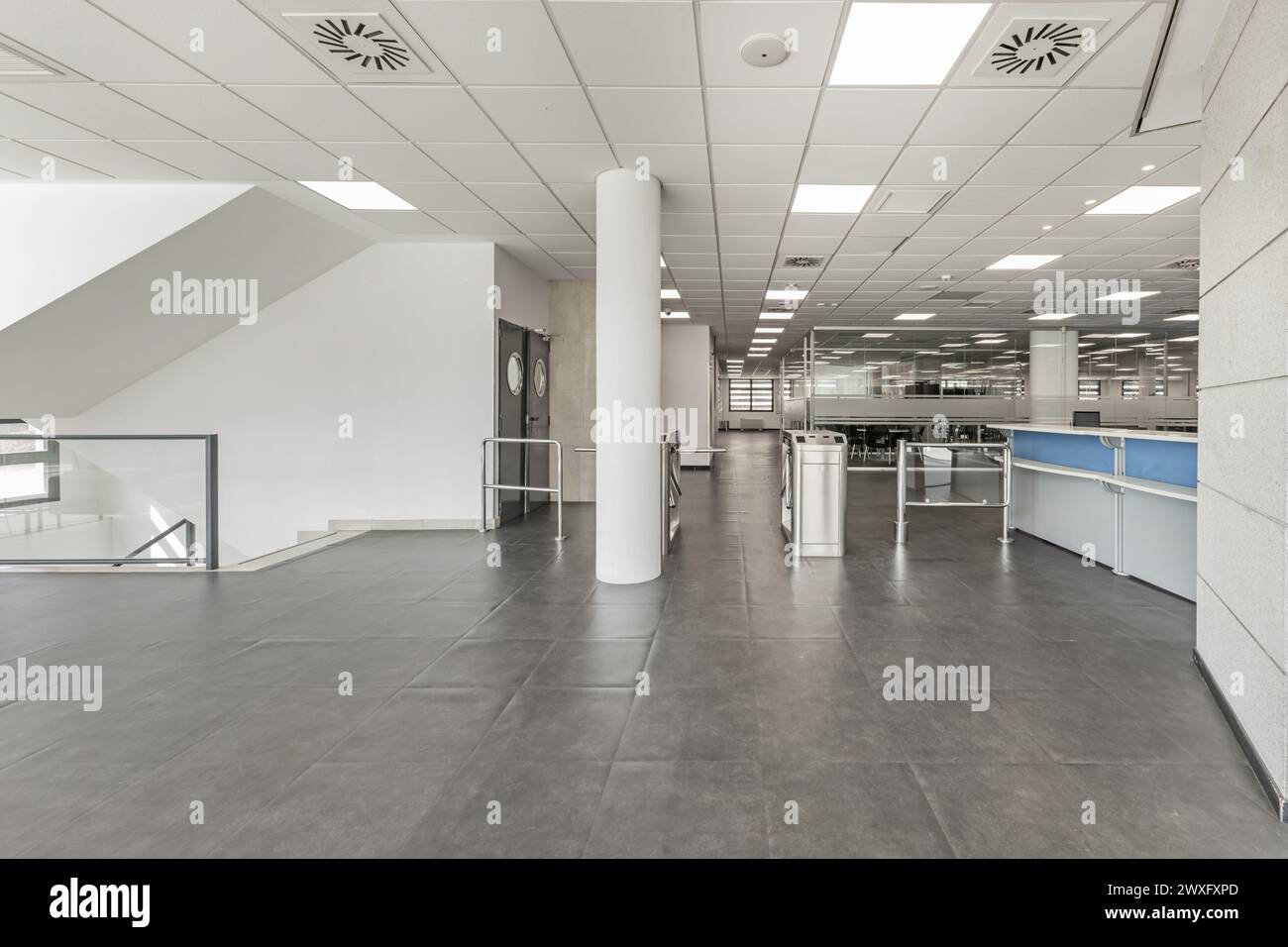Office access area with reception desk, technical ceilings, gray floors ...