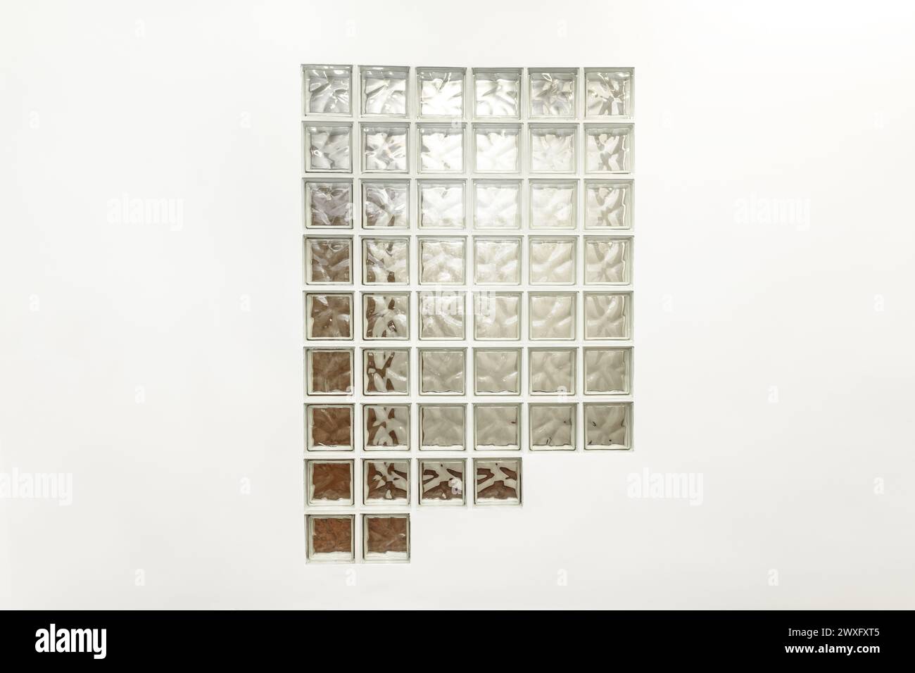 A white wall with a part built with semi-transparent glass bricks Stock ...