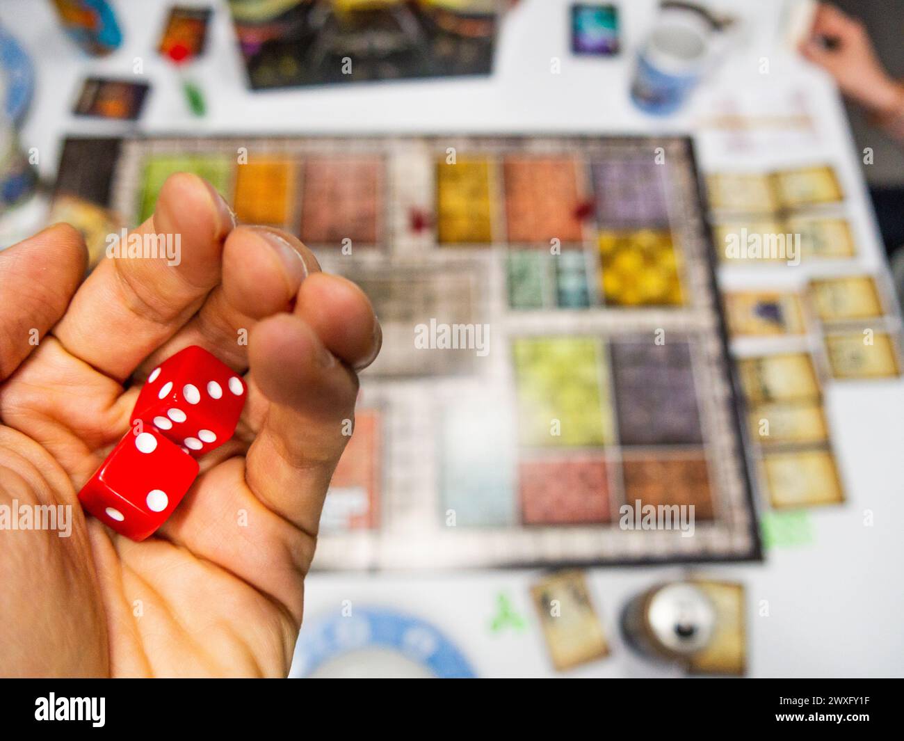 throwing dice on the game board with a three and a two at home in ...