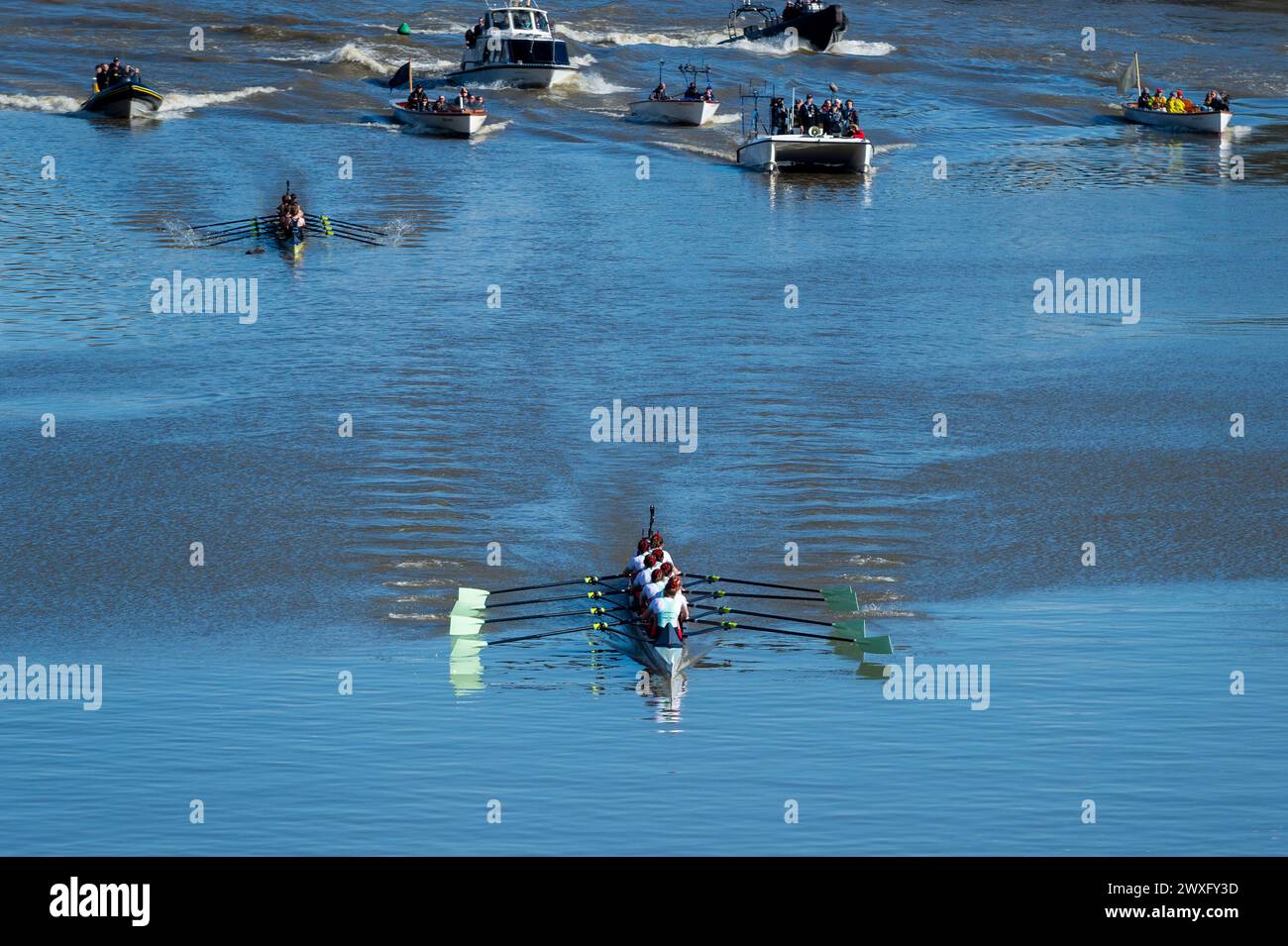 London, Britain. 30th Mar, 2024. Crew members of Cambridge (bottom) are ...