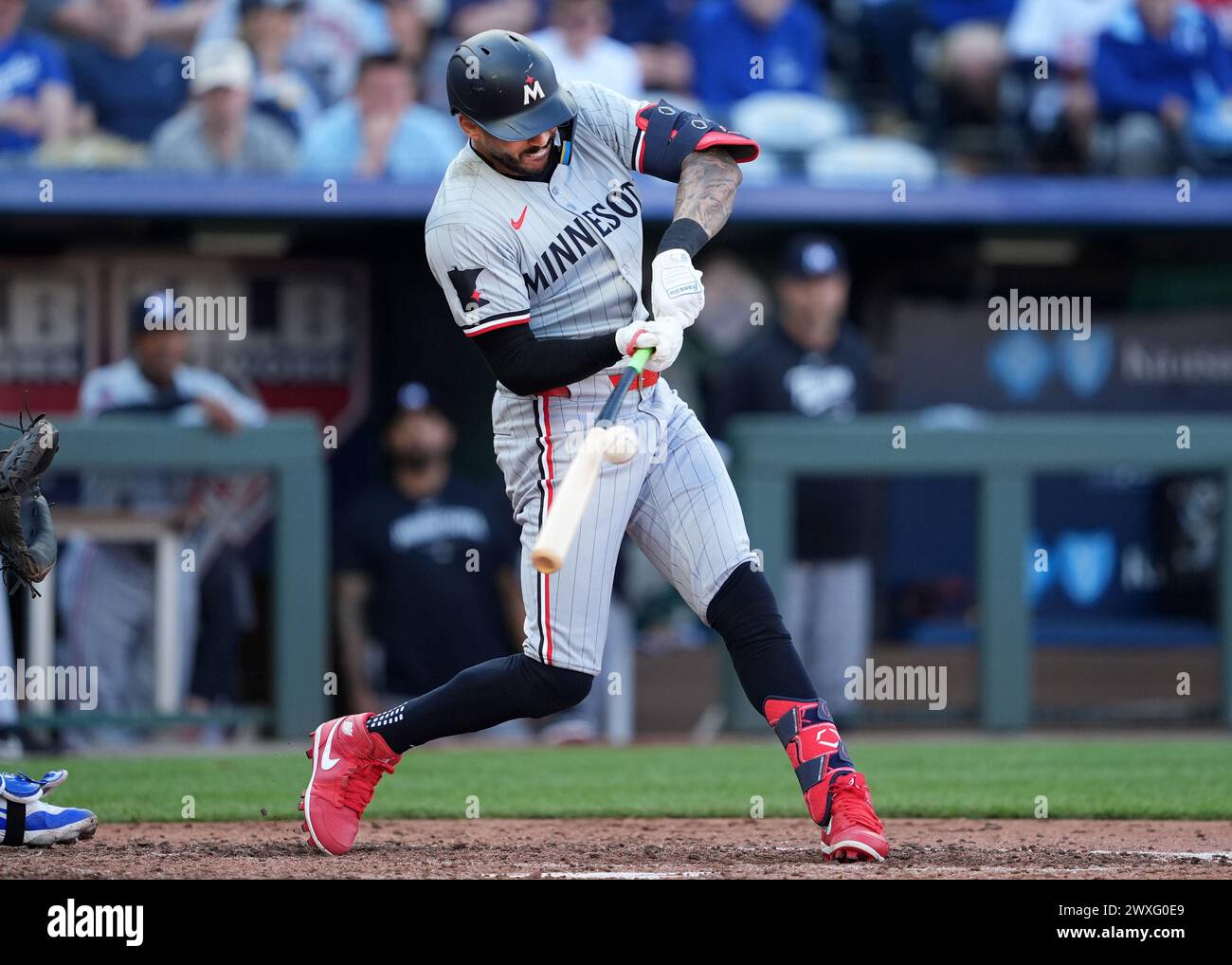 MAR 30, 2024: Minnesota Twins shortstop Carlos Correa (4) drives a pitch at Kauffman Stadium ...