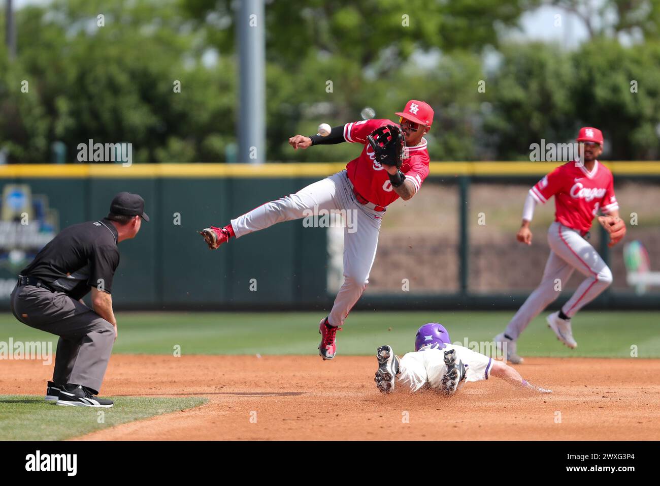 Arlington, Texas, USA. 30th Mar, 2024. Houston's HAROLD COLL (0) leaps ...
