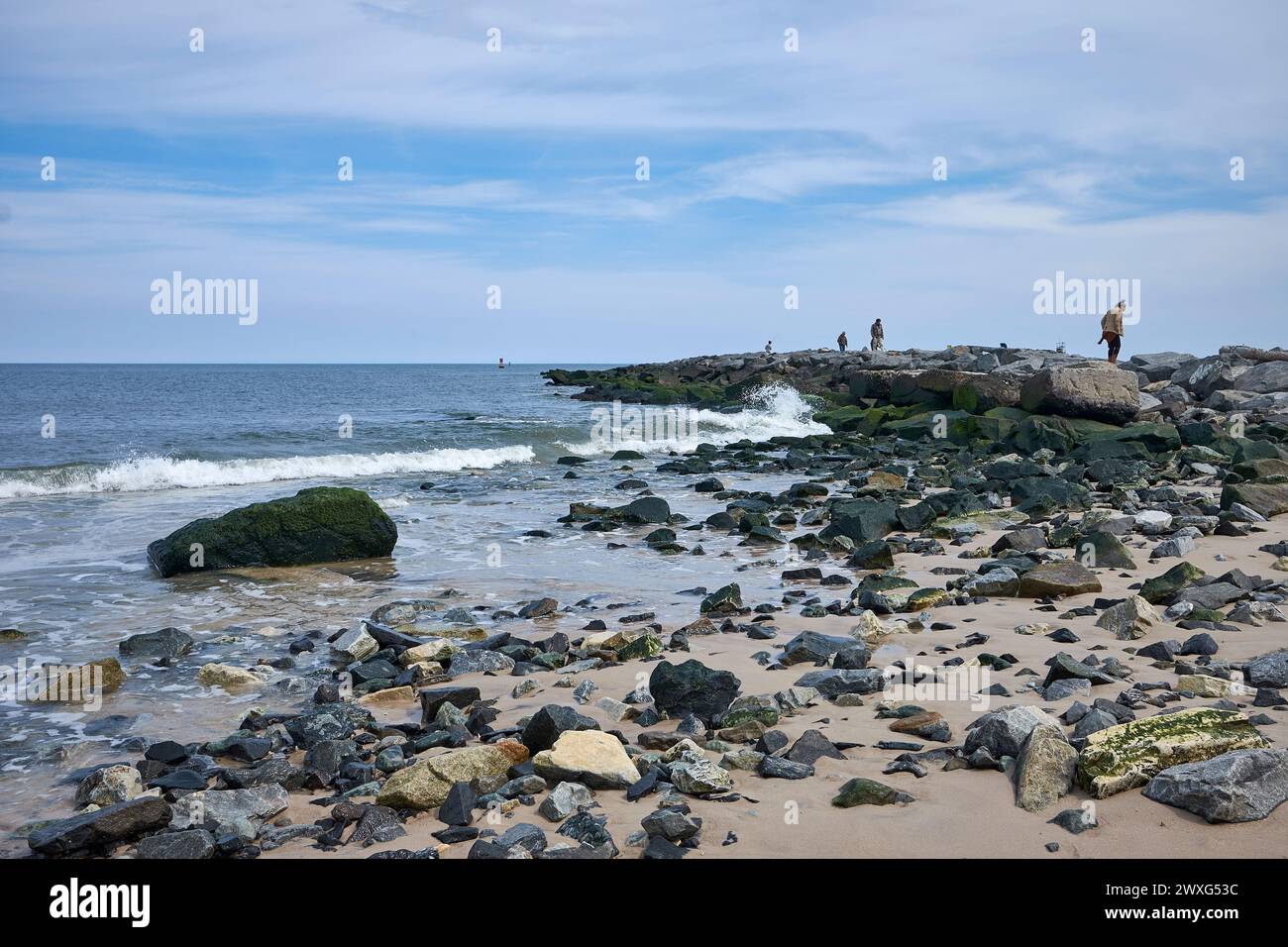 Fishermen line the breakwater at Delaware Seashore State Park's Indian ...