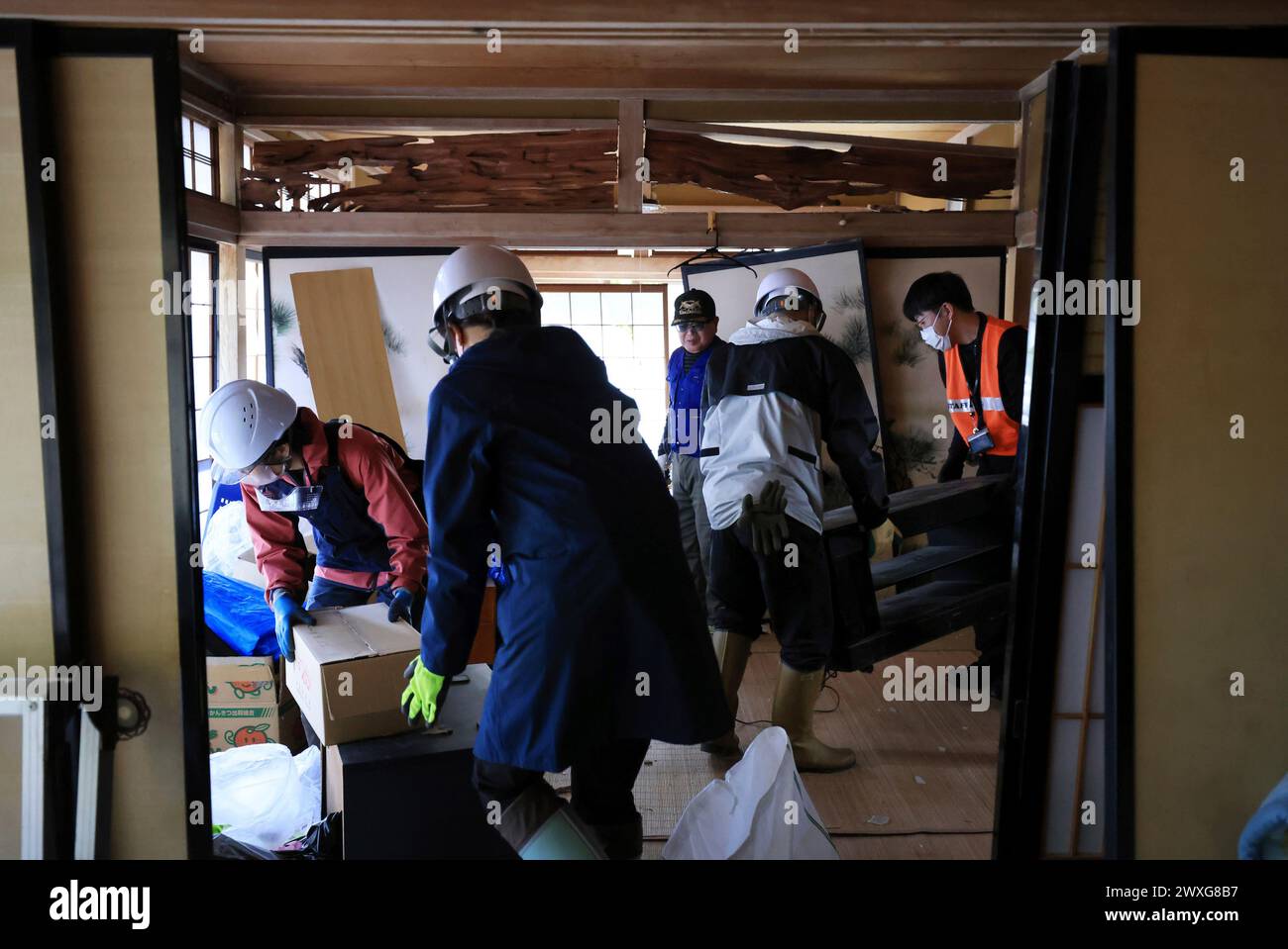 Volunteers help to clean up at disaster-stricken houses in Wajima City ...