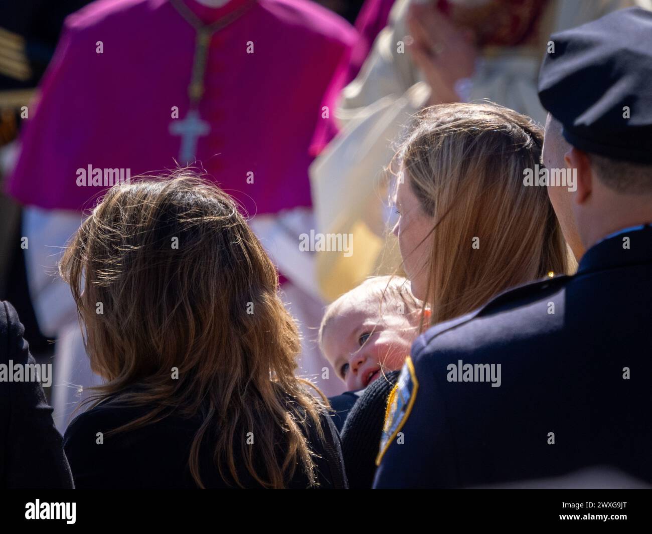New York, USA. 30th Mar 2024. Widow and one year old son await the ...