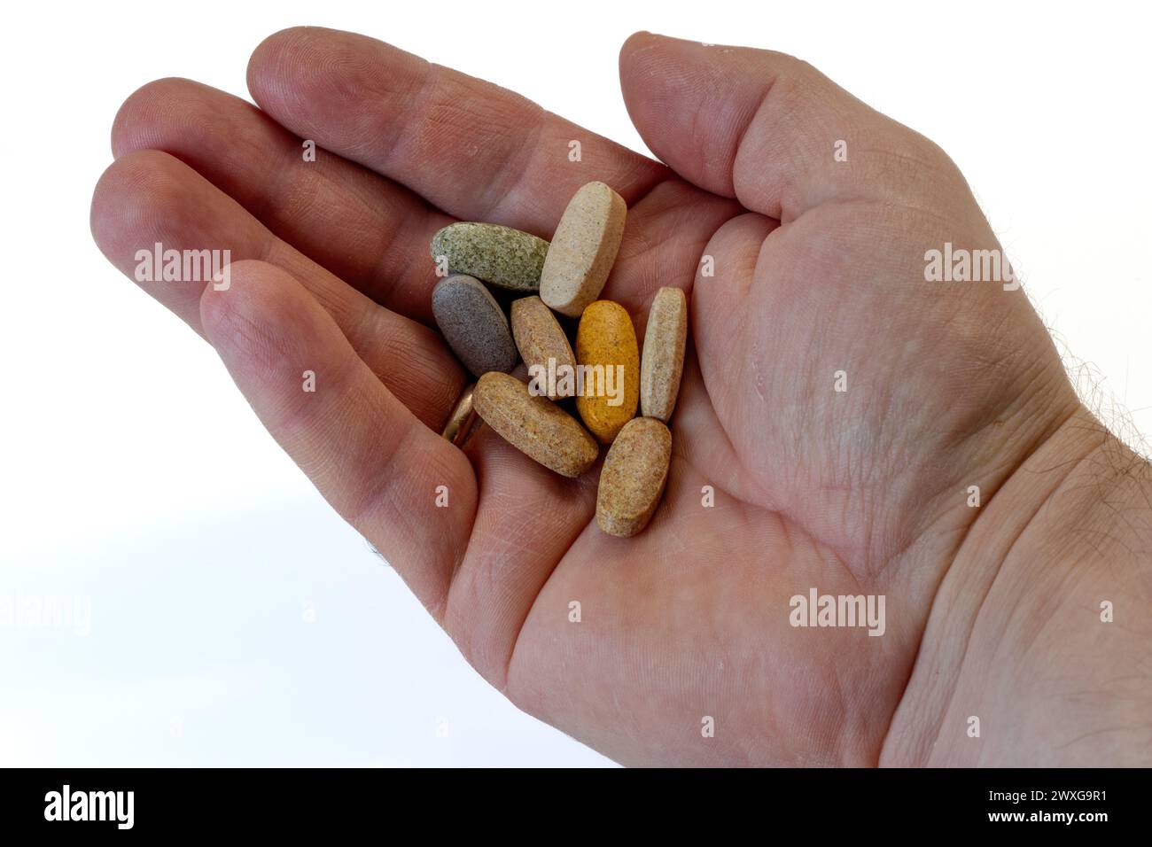 A portion of a dietary supplement of vitamins in hand Stock Photo - Alamy