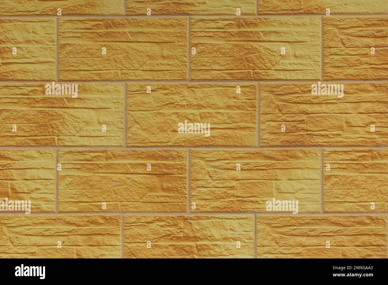 Yellow bright vibrant paint large brick blocks masonry wall texture ...