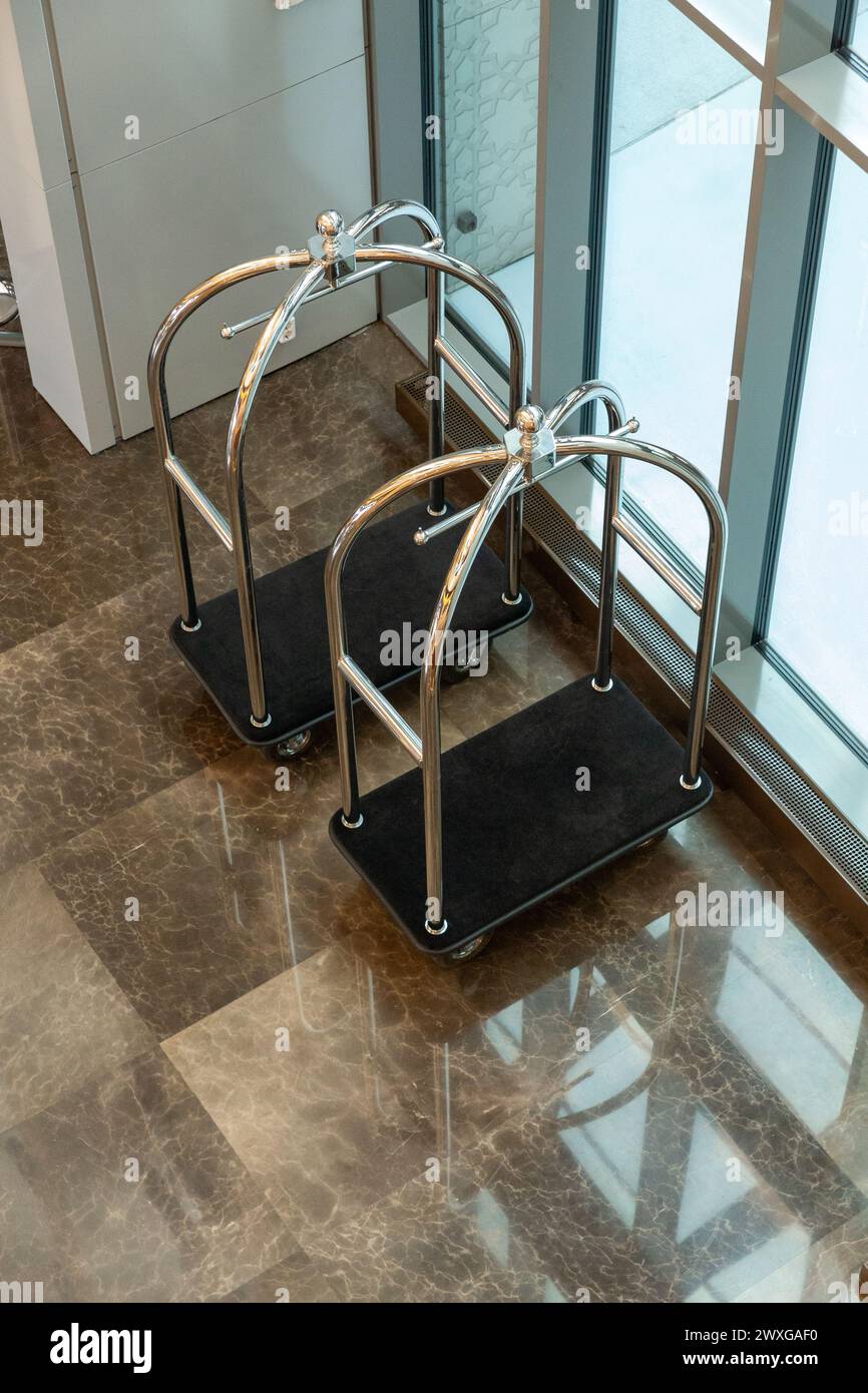 Vacant brass luggage carts at the entrance of a luxury city hotel ...