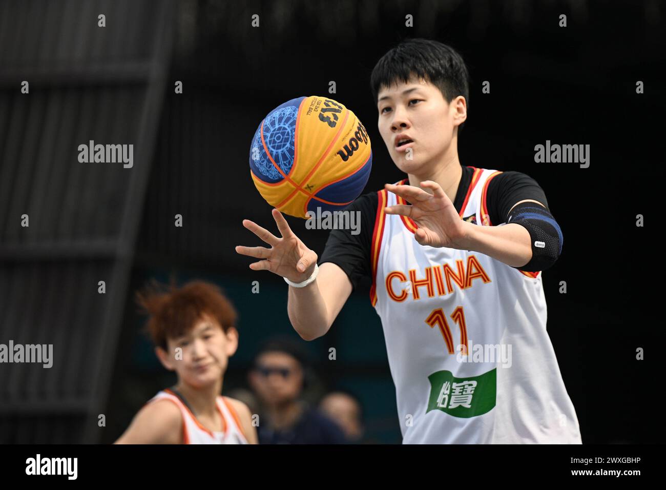 Singapore. 31st Mar, 2024. Ha Wenxi (R) of China passes the ball during ...