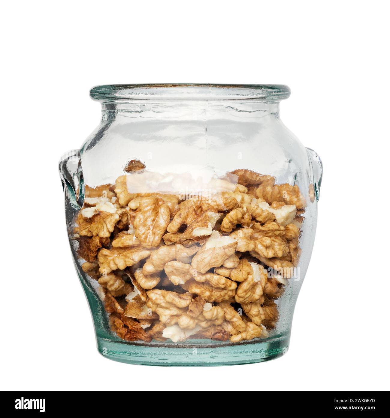 Delicious peeled walnuts in a glass jar isolated on white background ...
