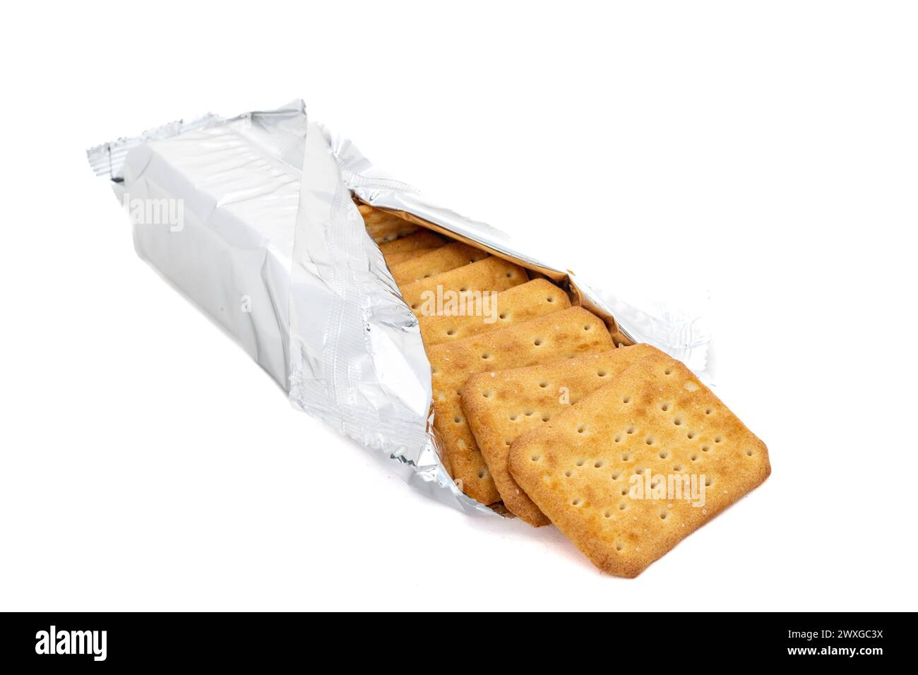 Salty crunchy cracker cookies in a wrapping paper on white isolated ...
