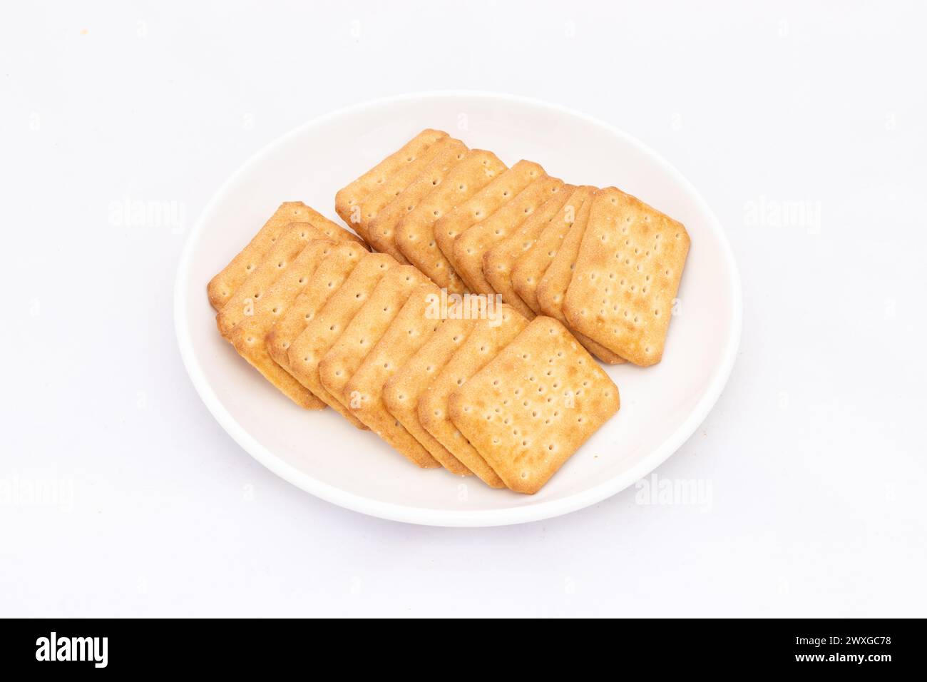 Delicious crackers with salt in plate on white background Stock Photo ...