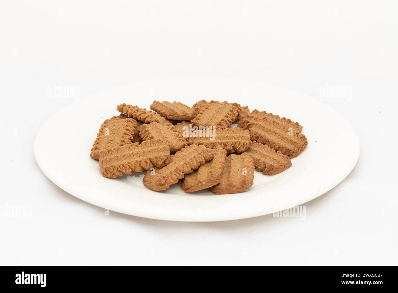 Dark brown sugar sweet biscuits in plate on isolated white background ...