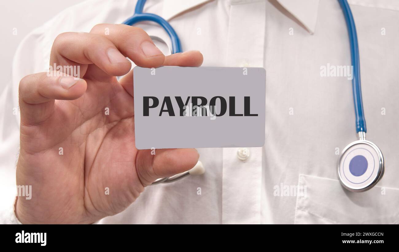 PAYROLL word on the card in the hand of a man in a white shirt Stock ...