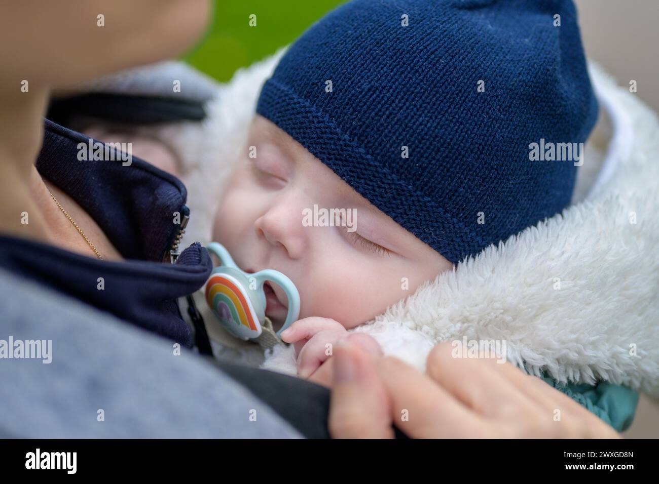 Extreme close up of little baby sleeping with a pacifier and holding ...