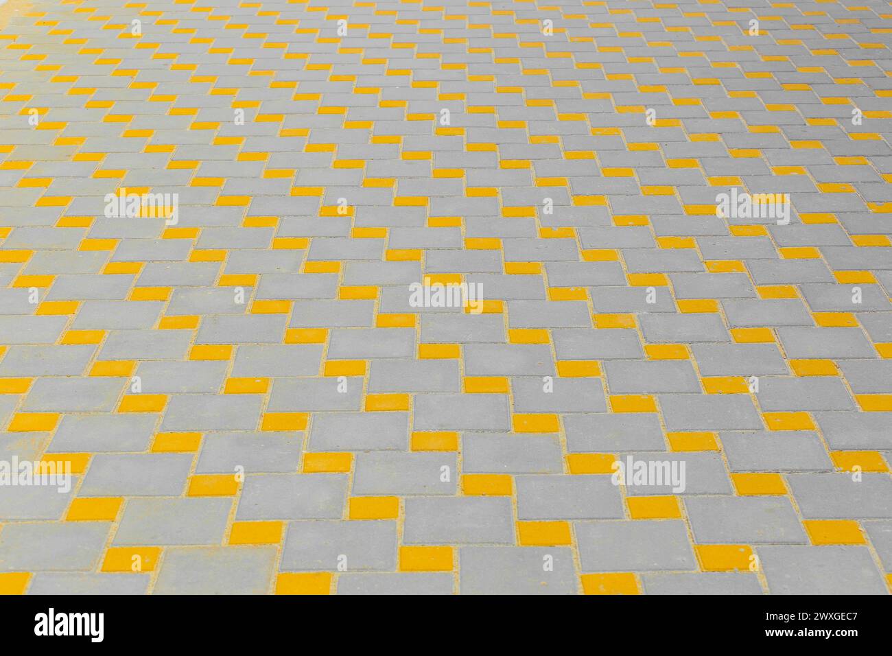 Abstract pattern of yellow and grey pavement tile street road surface ...