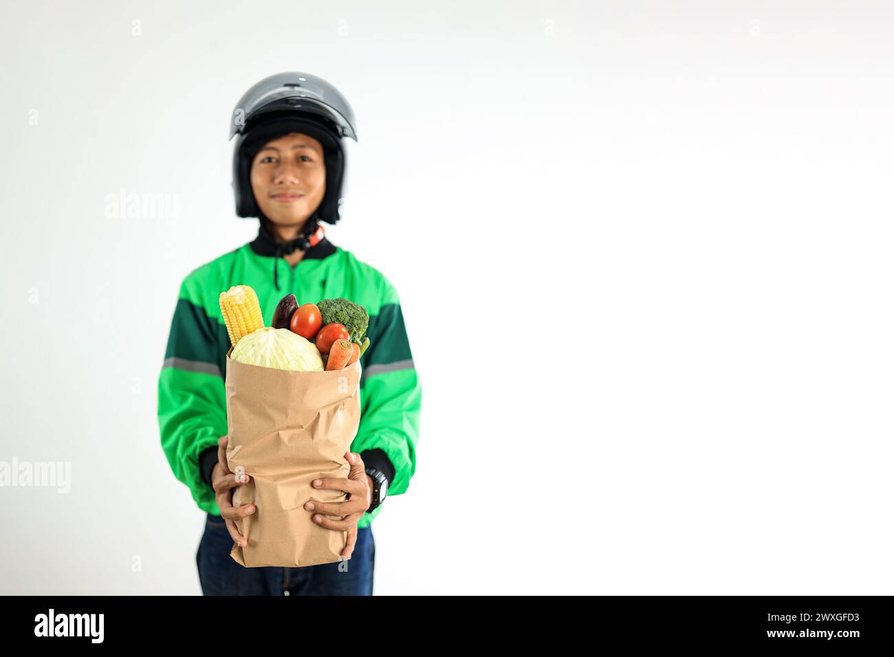 Asian Online Driver with Uniform and Helmet Delivering Fresh Vegetable ...