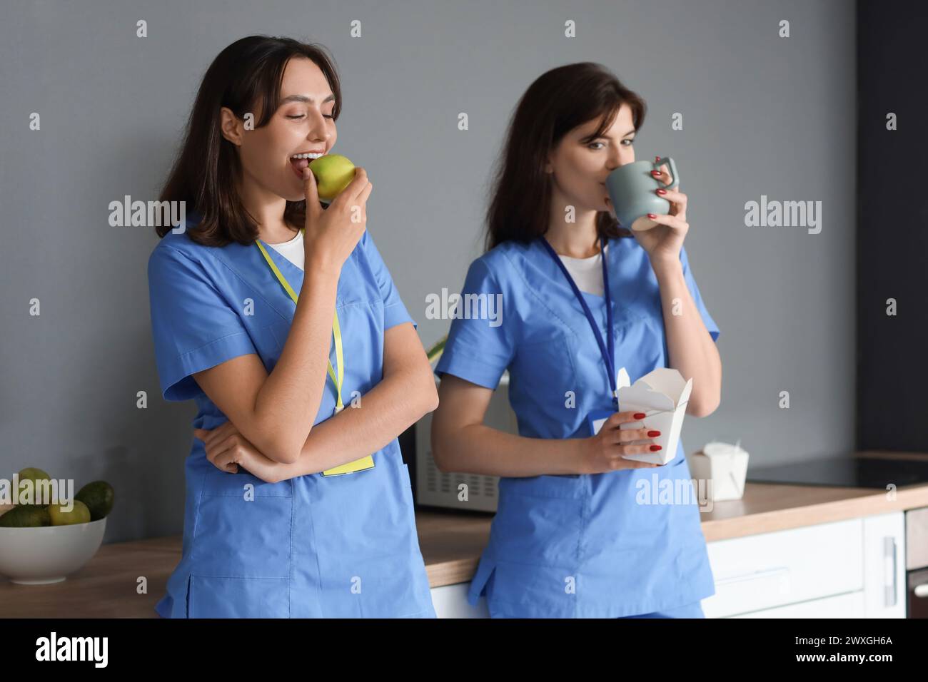 Female doctors having lunch in hospital kitchen Stock Photo - Alamy