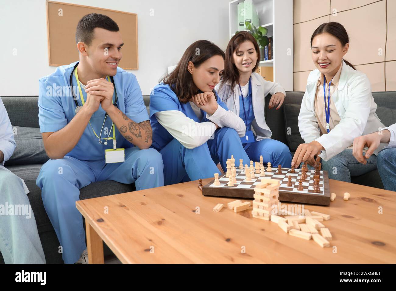 Team of doctors playing chess in hospital lounge Stock Photo - Alamy