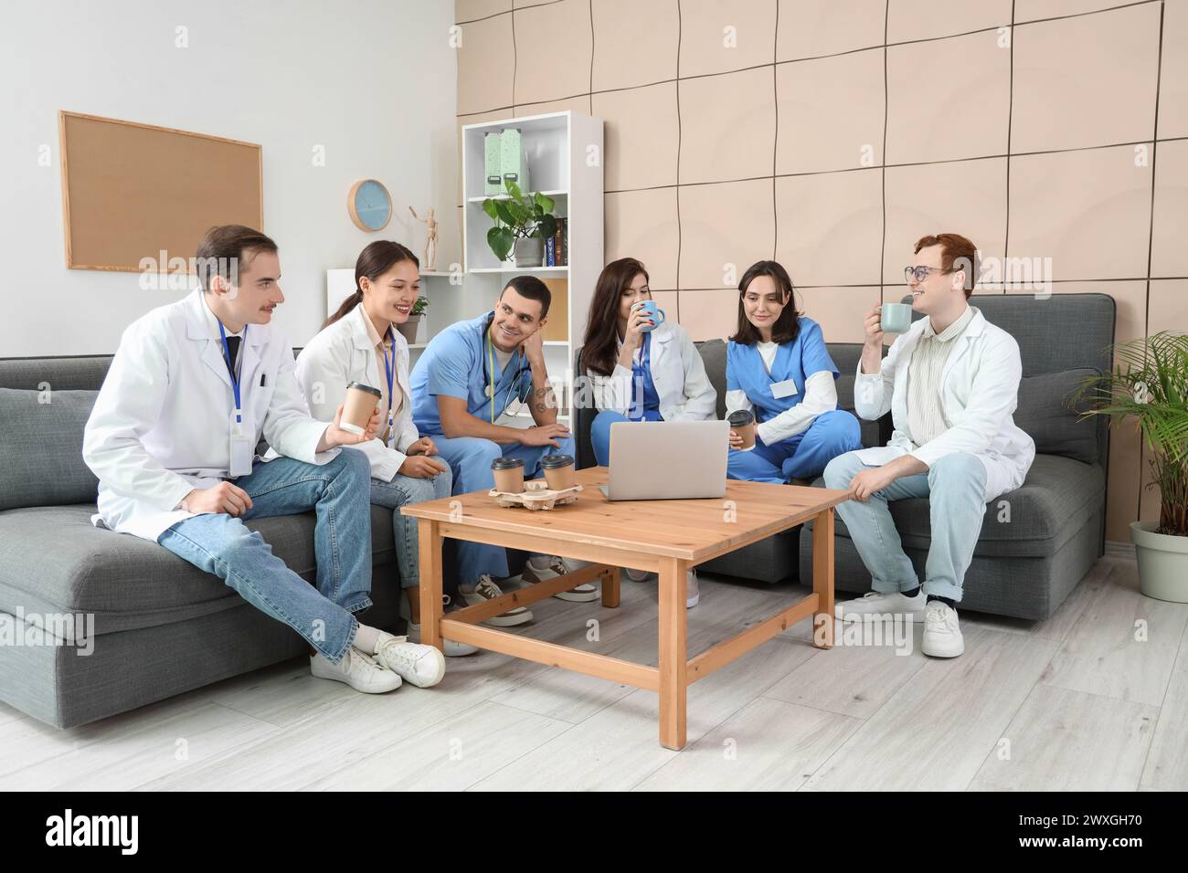 Team of doctors drinking coffee in hospital lounge Stock Photo - Alamy