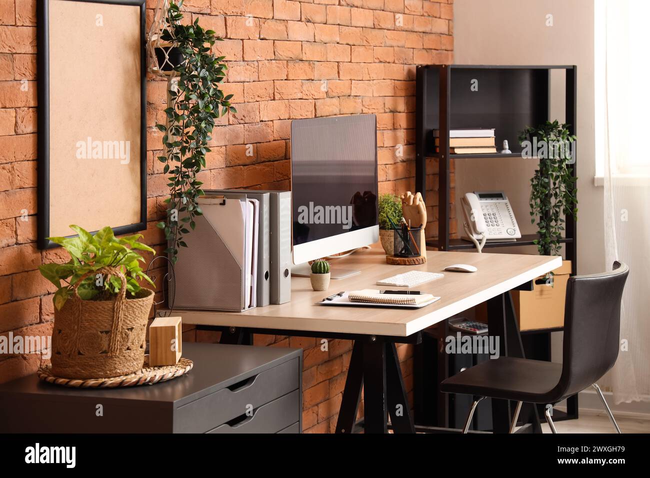 Blank computer monitor with folders on table in office interior Stock ...