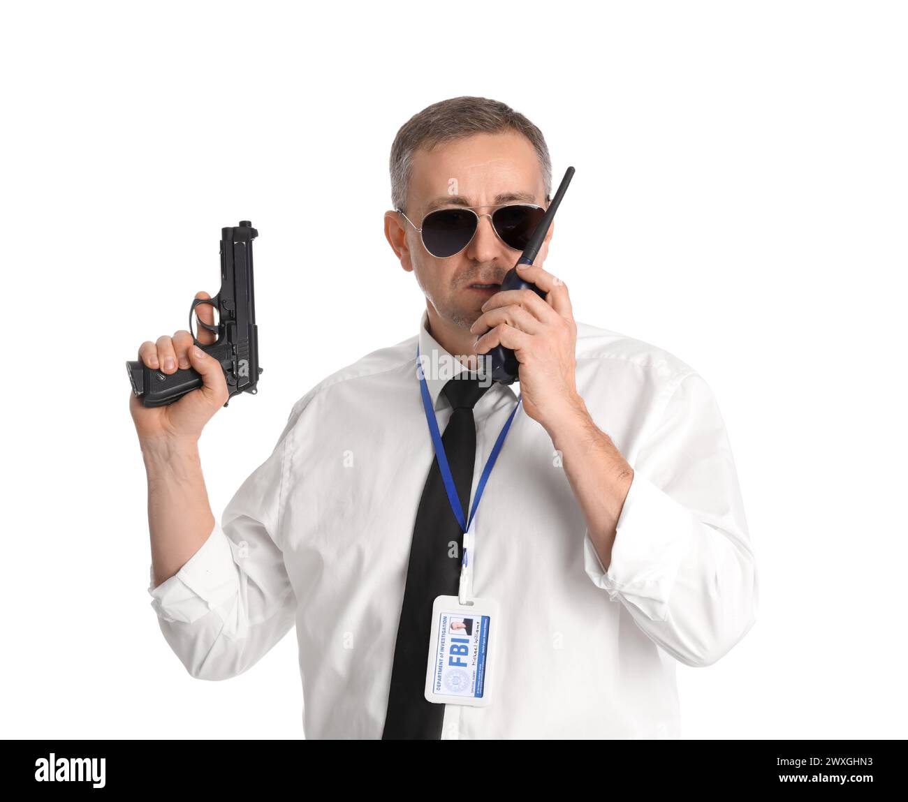 Mature FBI agent with two-way radio and gun on white background Stock ...