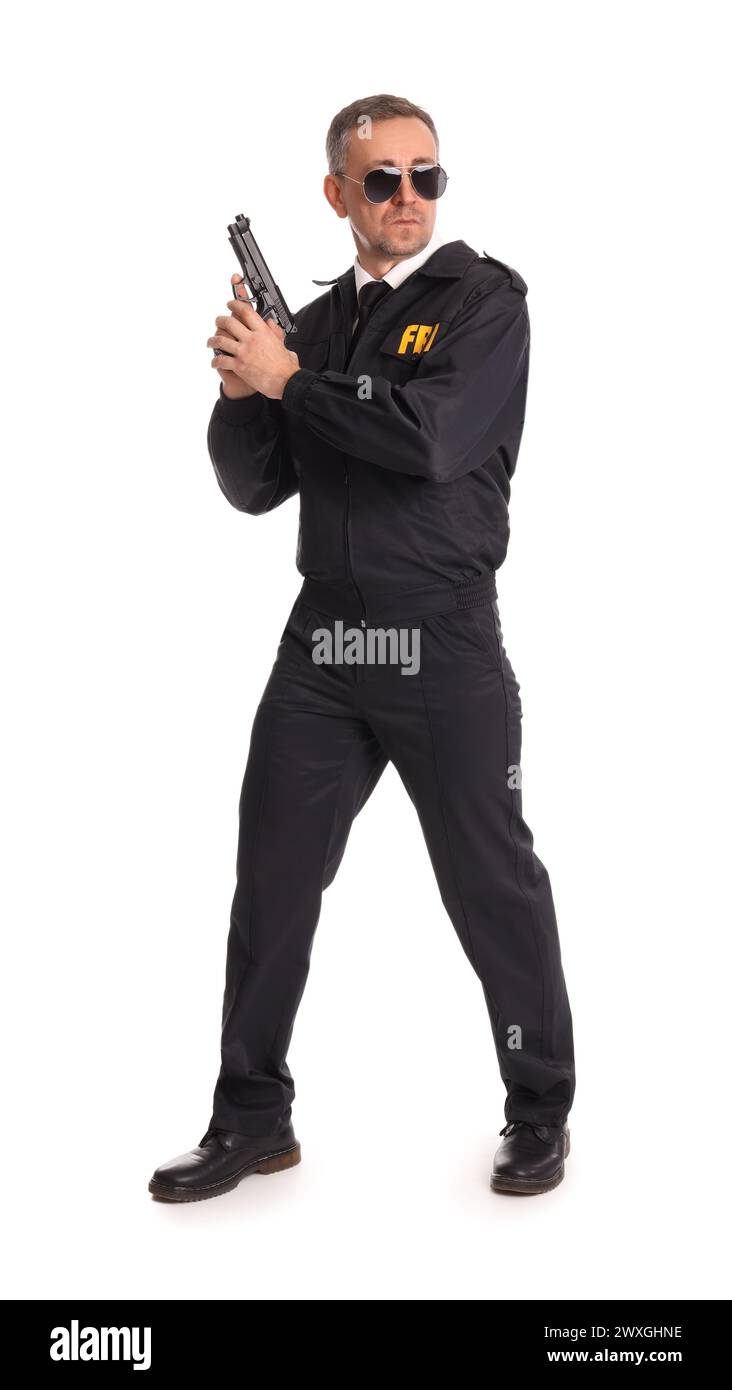 Mature FBI agent with gun on white background Stock Photo - Alamy