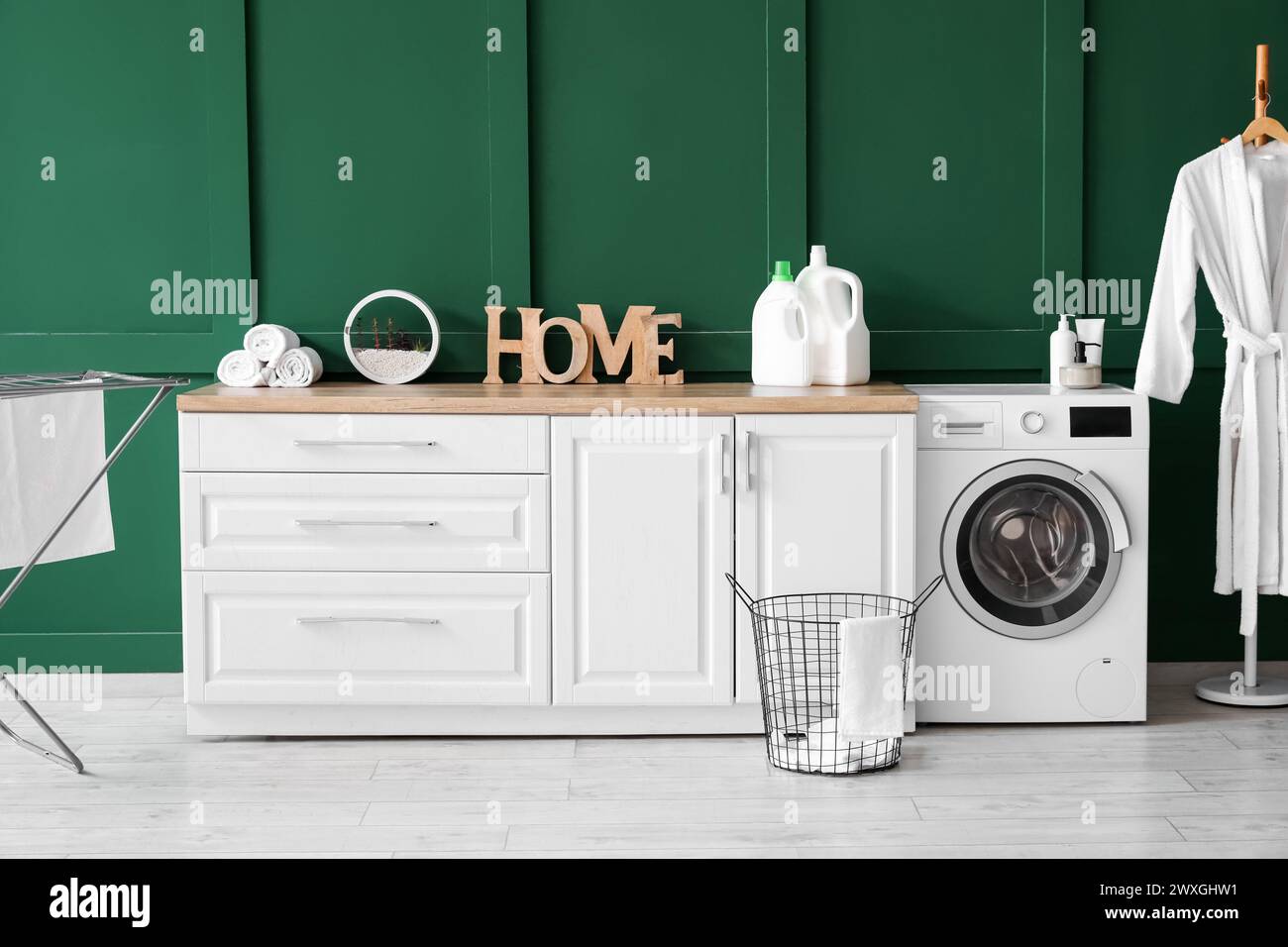 Interior of room with laundry basket, washing machine and counters ...
