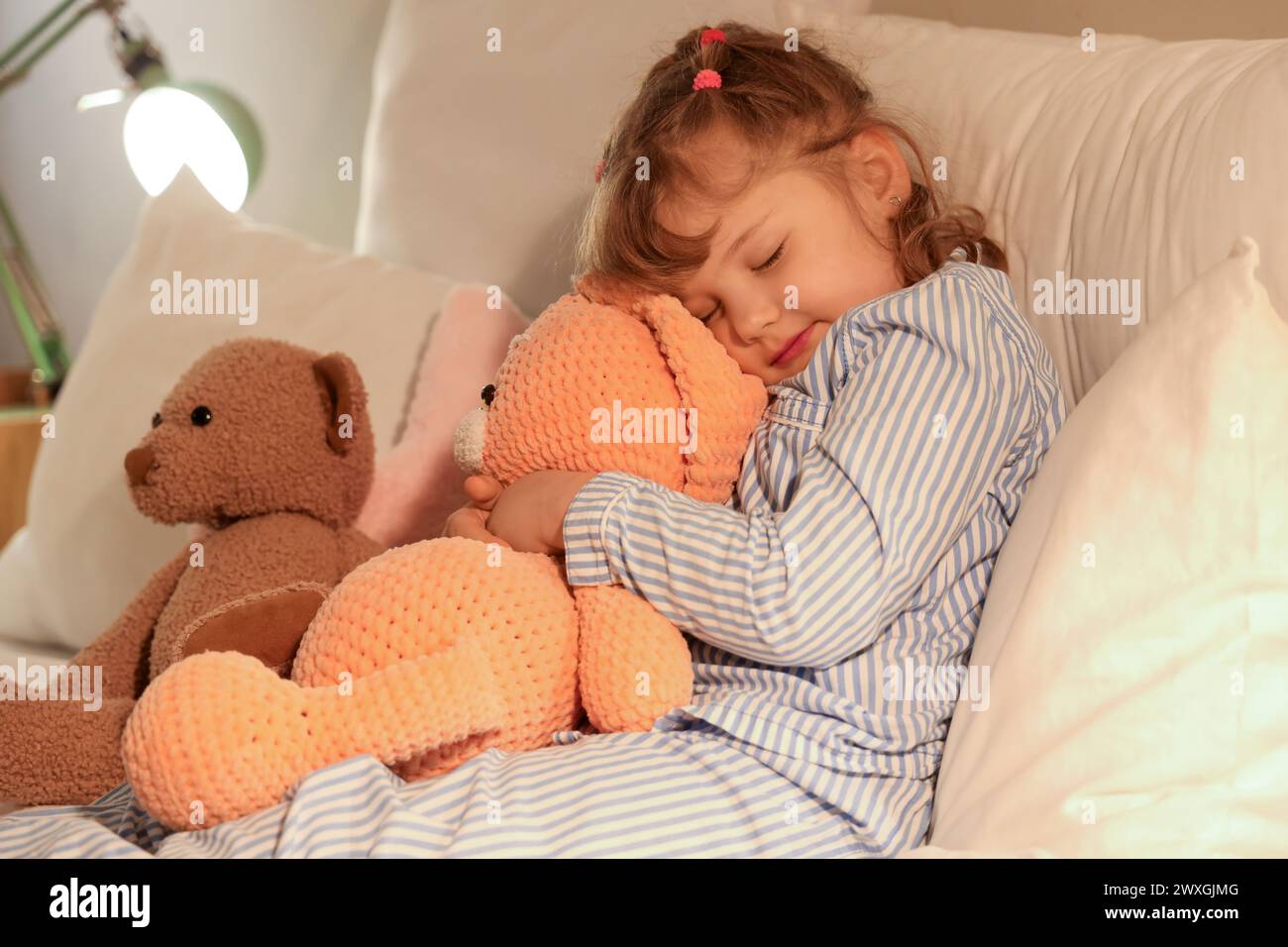 Adorable little girl with plush toys sleeping in bed Stock Photo - Alamy