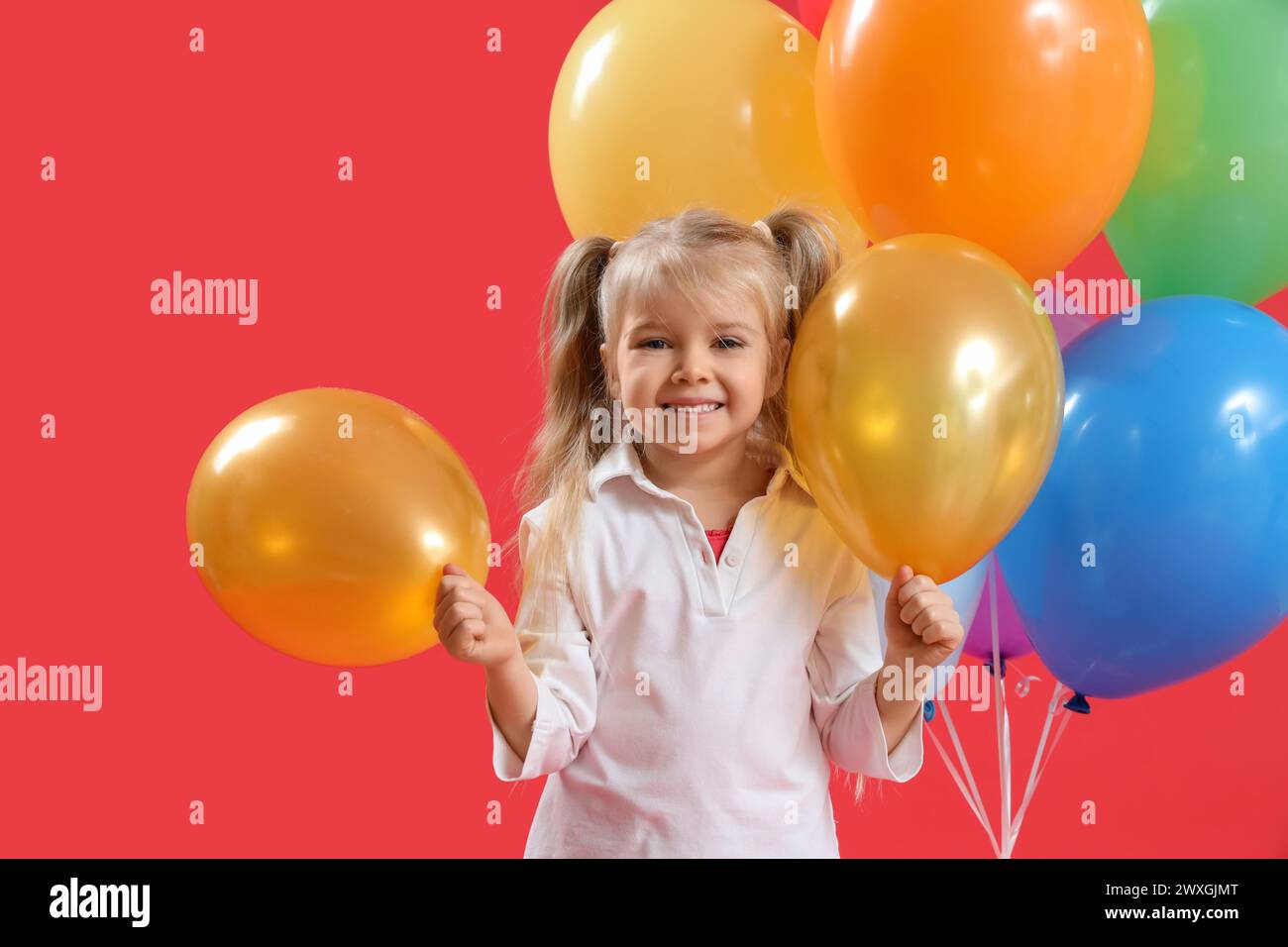 Cute little girl with colorful balloons on red background Stock Photo ...