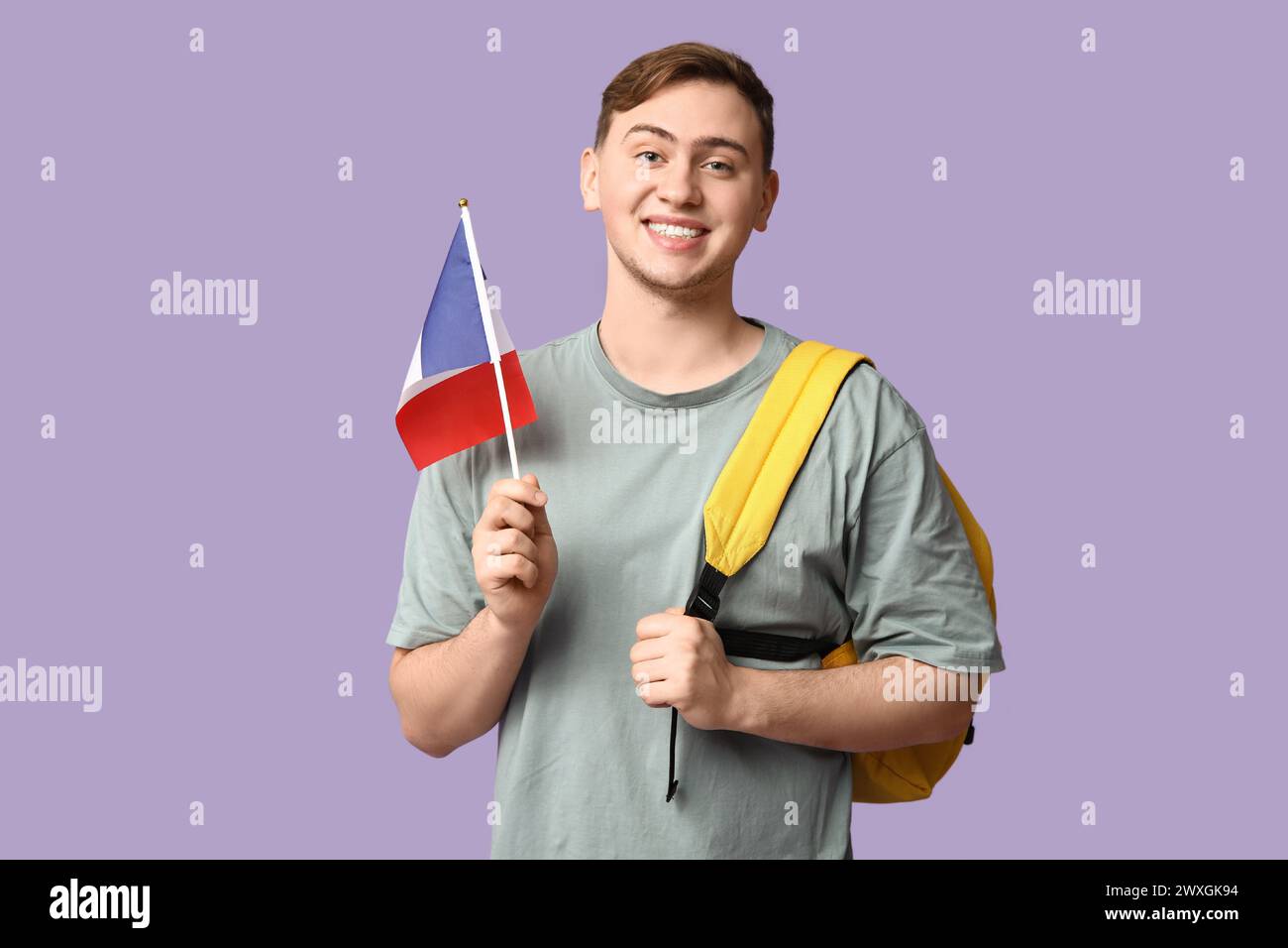 Male student with French flag on lilac background Stock Photo - Alamy