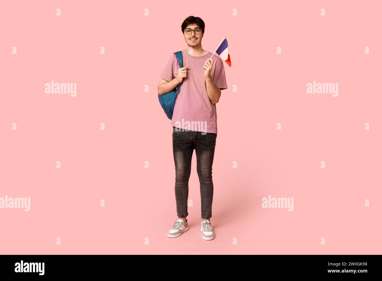 Male student with French flag on pink background Stock Photo - Alamy