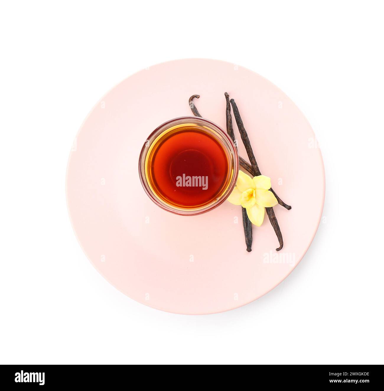 Bowl of vanilla extract, sticks and flower on white background Stock ...