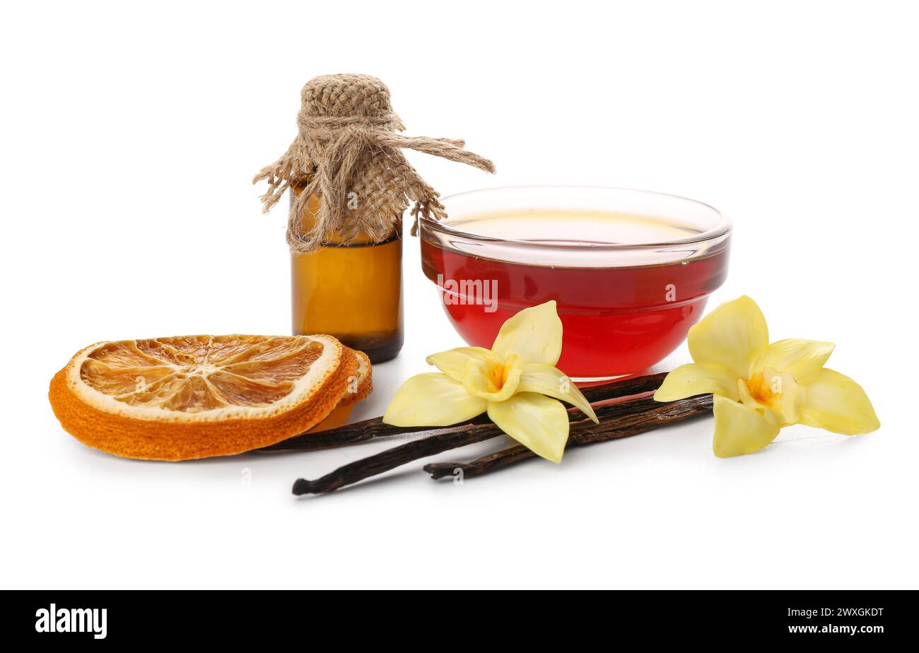 Composition with vanilla extract, sticks and flowers on white ...