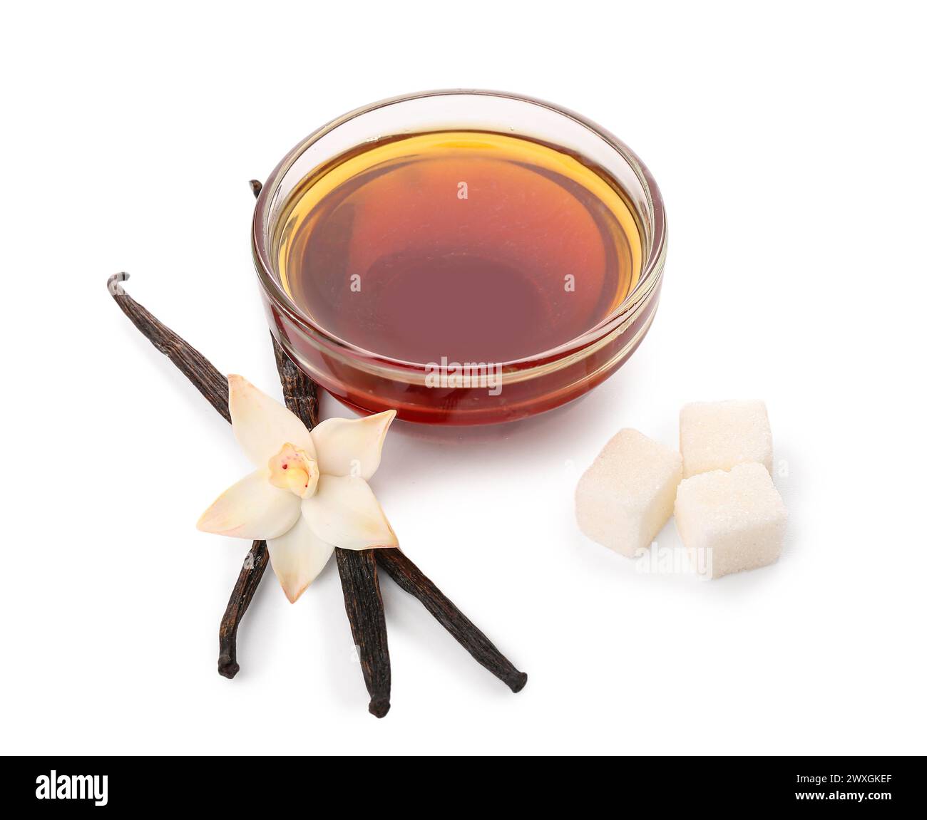 Bowl of vanilla extract, sticks and sugar on white background Stock ...