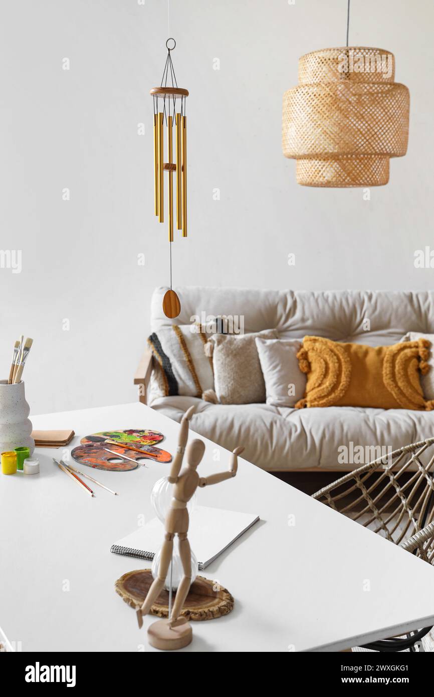 Interior of light room with wind chime and artist's workplace Stock ...