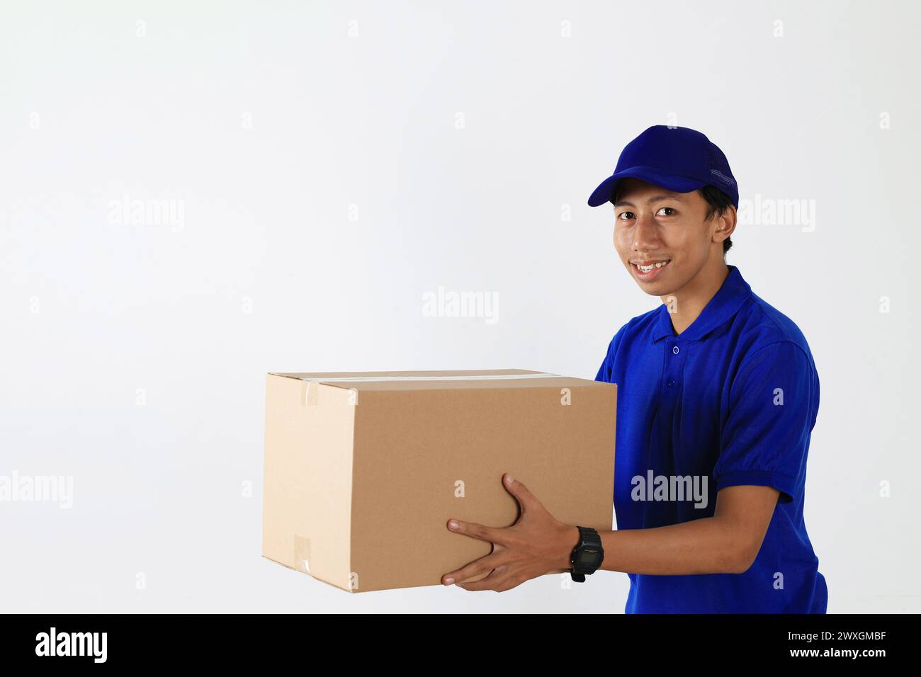 Delivery Man in Blue Uniform Send Package in Cardboard Box. Male ...